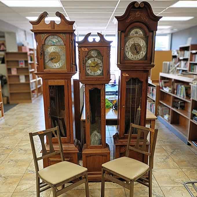 Three grandfather clocks standing together like they're auditioning for a timekeeping boy band reunion.