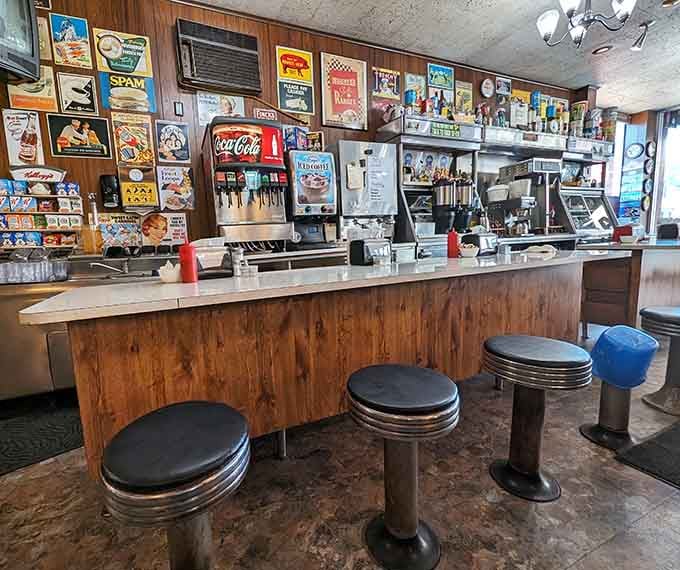 Counter seating lined with vintage signs offers front-row seats to the breakfast theater happening behind the grill.