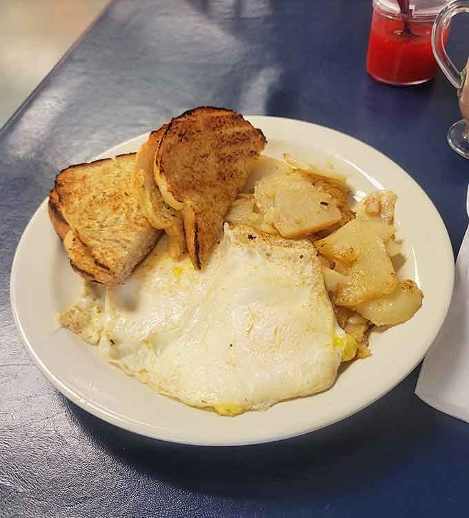 A breakfast plate featuring eggs, home fries, and toast that starts your day off absolutely right.