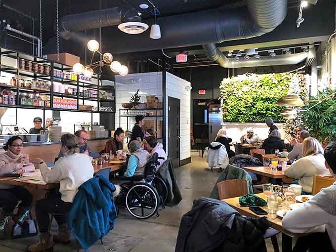 The buzz of conversation and clinking silverware fills this welcoming space where strangers become friends over shared breakfast experiences.