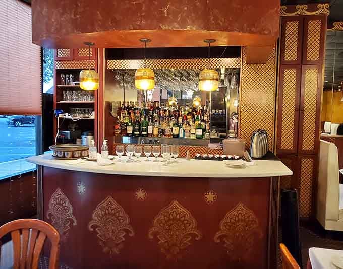 A full bar with traditional Indian design elements, because sometimes your curry needs a perfectly paired beverage companion.