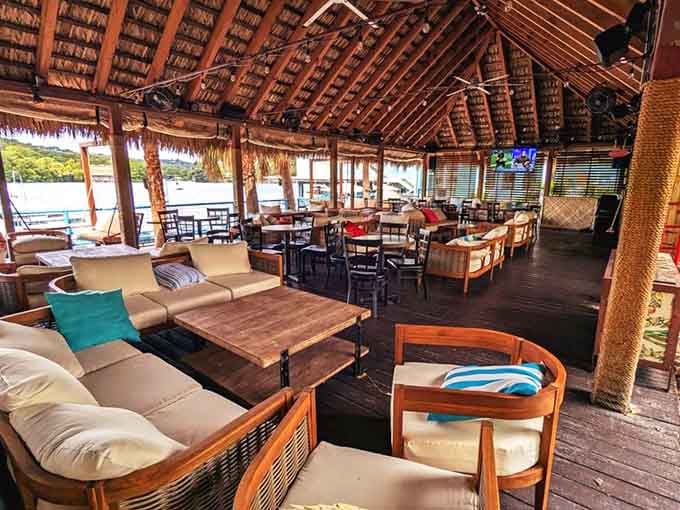 The palapa-covered outdoor lounge area with plush seating makes you want to cancel all your afternoon plans immediately.