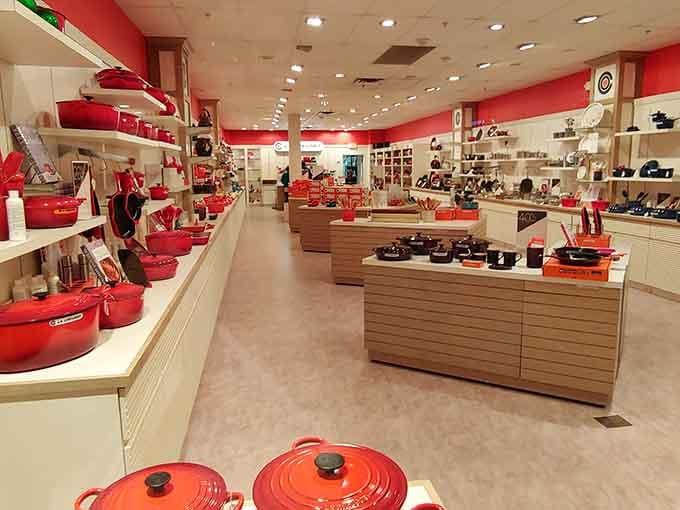 Le Creuset's vibrant cookware displayed like edible art, tempting you to finally become the chef you pretend to be.