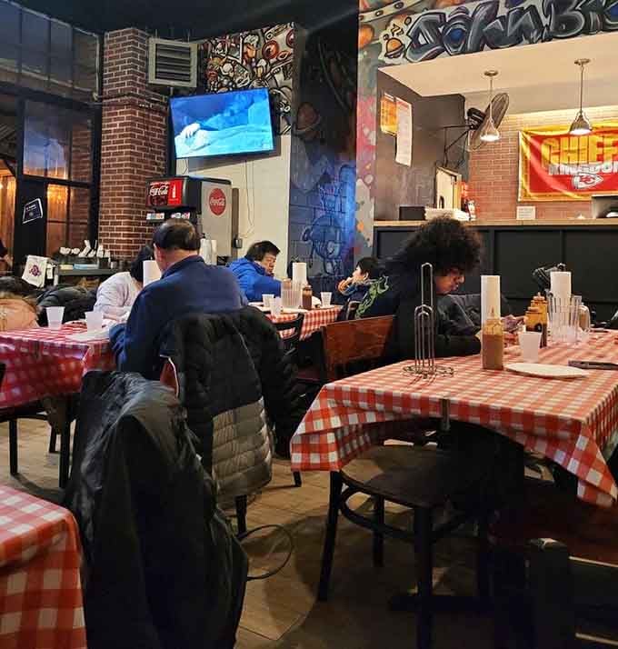 Real people enjoying real food at checkered tables proves this spot has become a neighborhood gathering place for good reason.