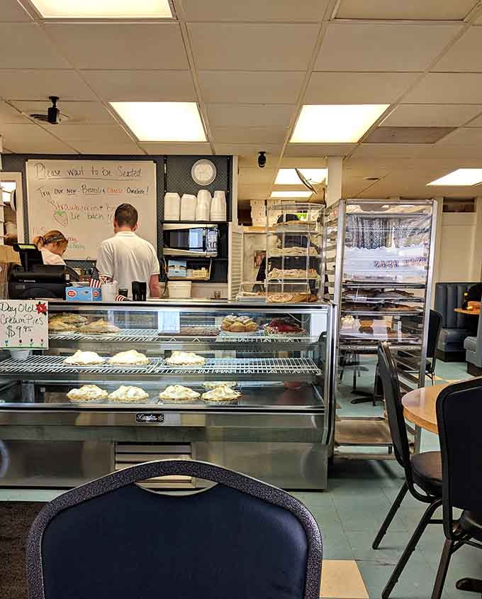 The counter and display case showcase fresh pies and the organized chaos of a kitchen that actually cares.