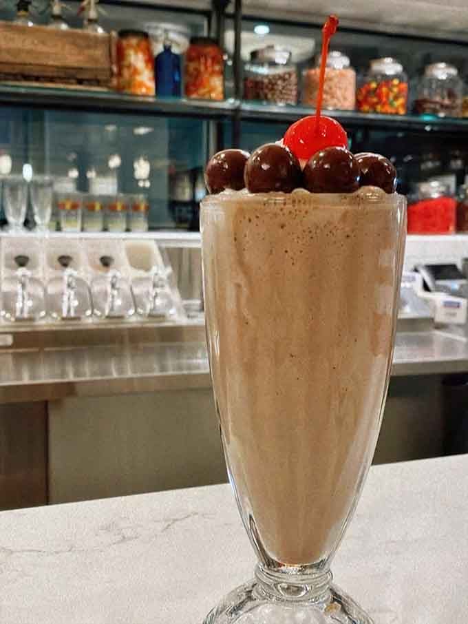 Topped with chocolate-covered cherries and a bright red cherry, this milkshake means serious business about dessert.