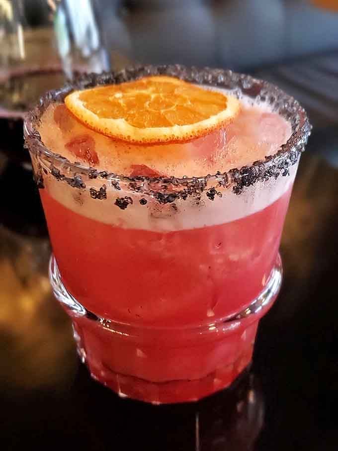 This vibrant cocktail with its black sugar rim and orange garnish proves the bar program takes drinks as seriously as the kitchen.