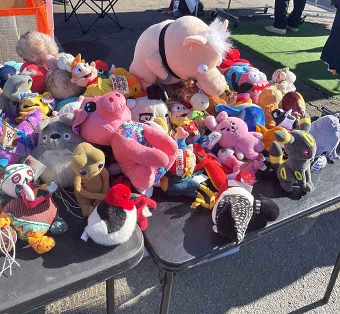 That giant pink pig presides over this stuffed animal kingdom like a plush monarch surveying its cuddly subjects.