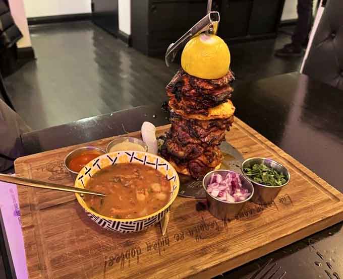 Al pastor stacked so high it defies physics, served with all the fixings for maximum customization and enjoyment.