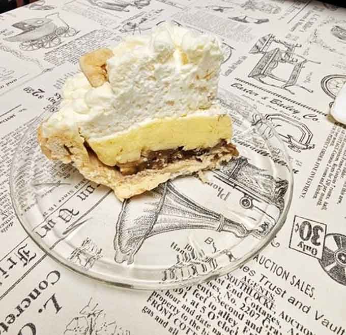 Banana cream pie layered with meringue towers like a sweet, wobbly monument to dessert perfection.