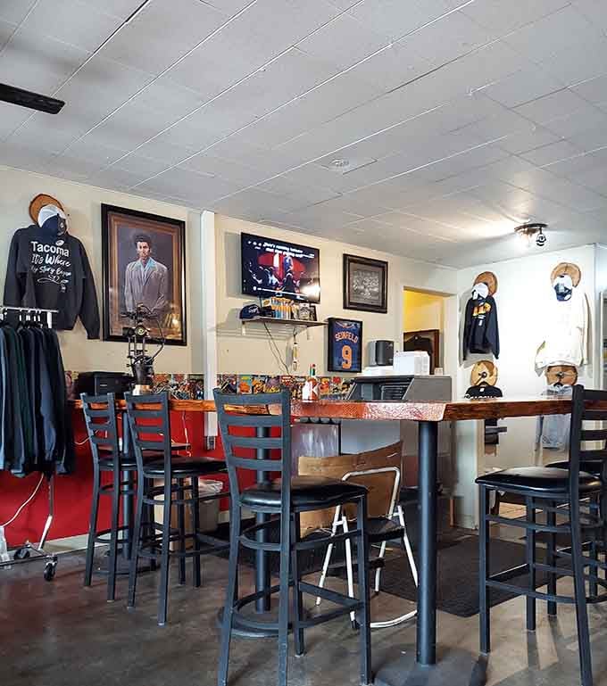 High-top seating and walls covered in framed photos create an intimate dining space that encourages lingering over coffee.