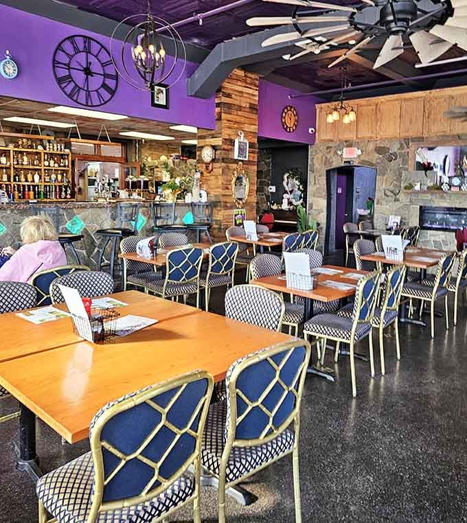 The dining area balances whimsy with sophistication, featuring a stone fireplace that adds unexpected warmth to Wonderland.