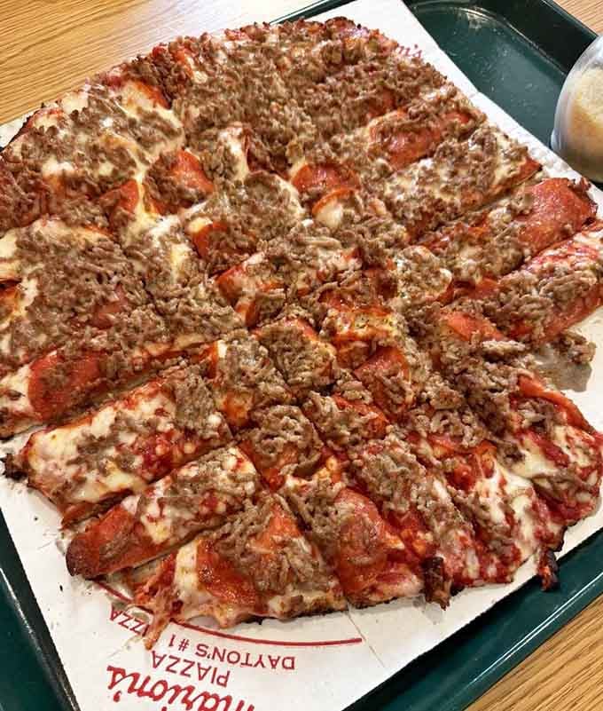 Double the meat means double the happiness, served on a crust so thin it practically defies the laws of physics.
