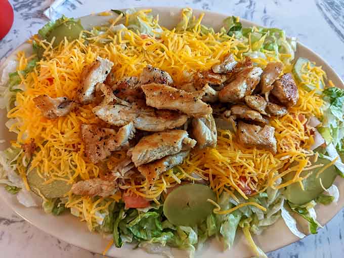 Grilled chicken piled high on fresh greens with enough cheese to make any salad worth eating happily.