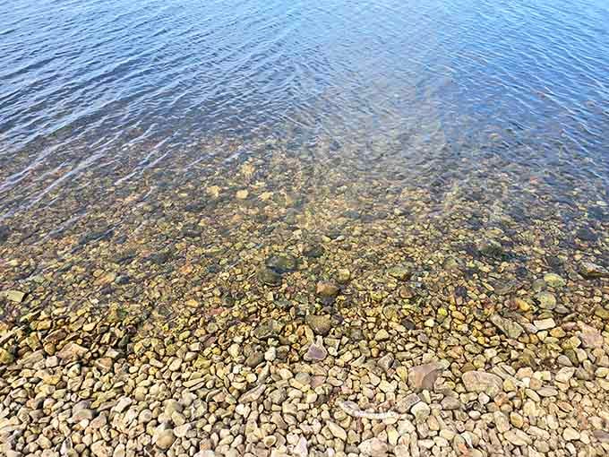 The crystal-clear water reveals a pebbled bottom that's easier on your feet than you'd expect.