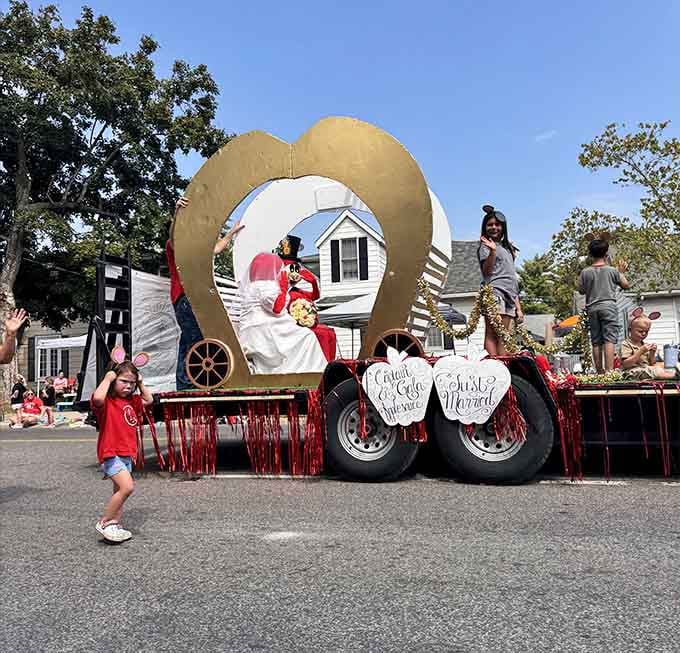 Captain Applesauce and friends wave from their golden apple chariot, spreading fruity cheer to the adoring crowds below.