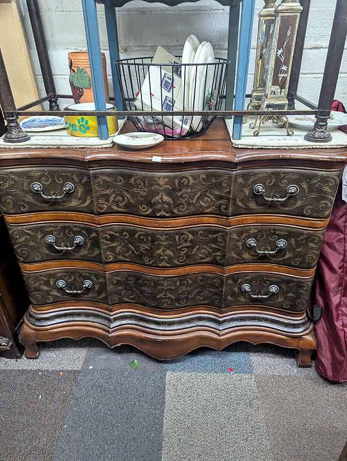 Ornate carved details on this dresser prove they really don't make furniture like this anymore, folks.