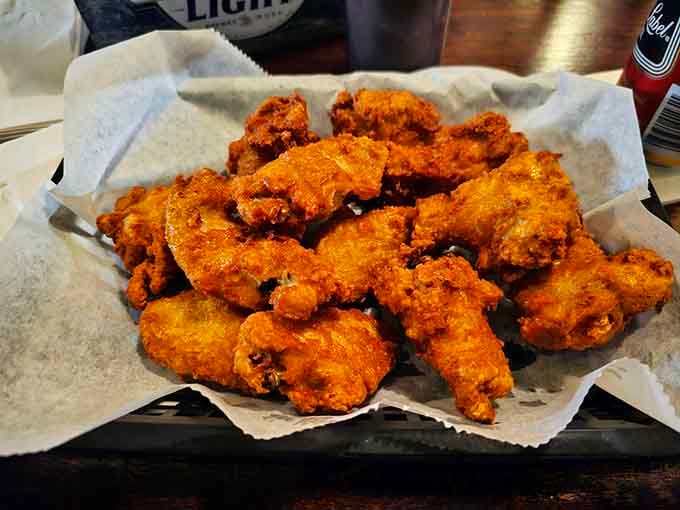 Crispy wings piled high like edible treasure, the kind of bar food that keeps people coming back for generations.