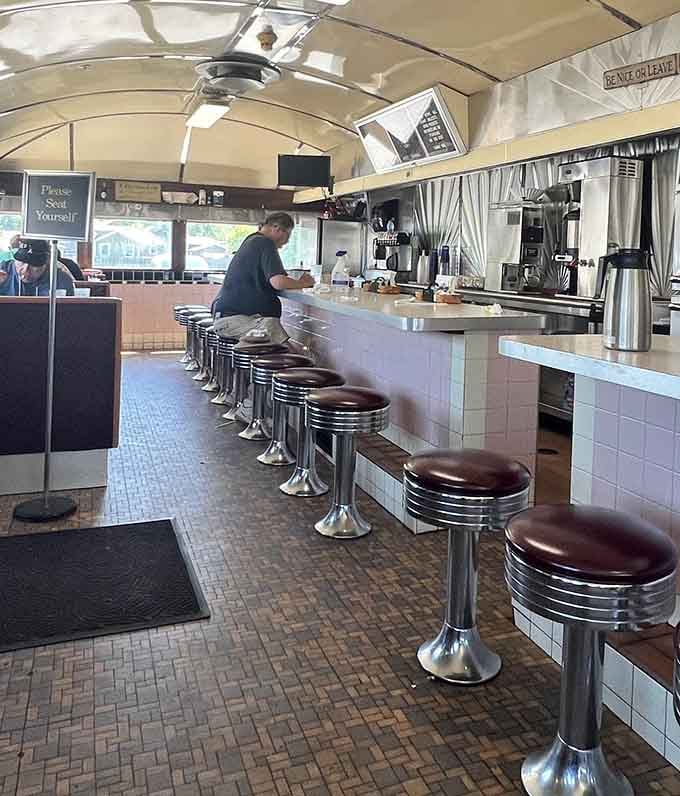 Classic counter seating with chrome stools invites solo diners to enjoy breakfast while watching the kitchen magic happen.