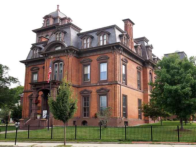 The public library standing dignified in brick, offering free entertainment that beats cable television any day of the week.