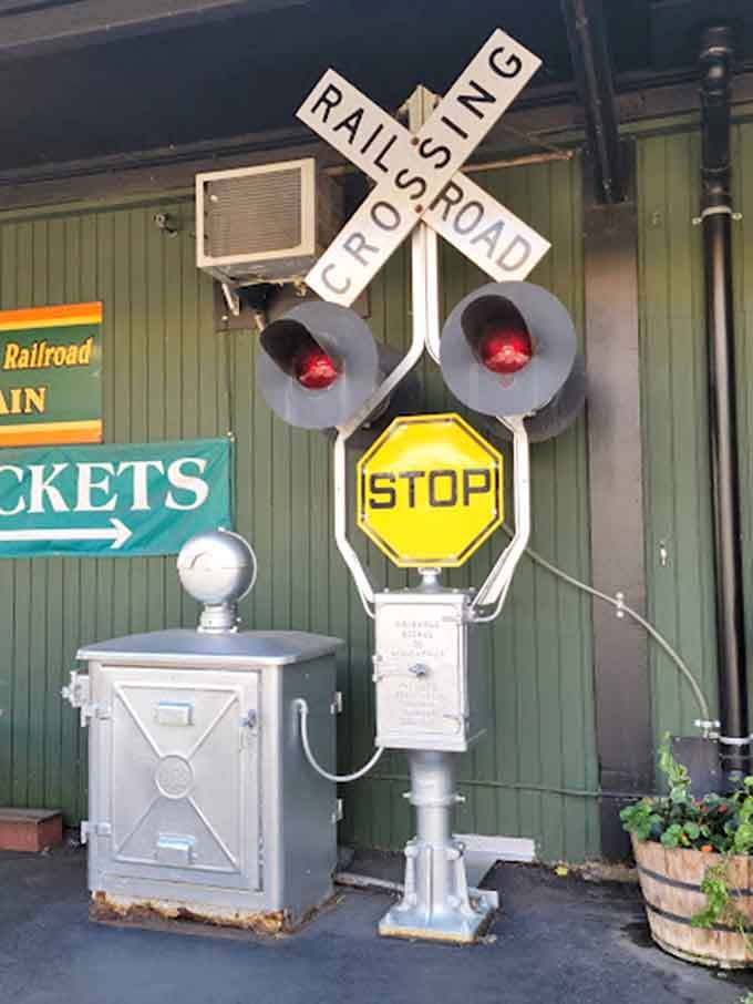 This classic railroad crossing signal stands guard like a faithful sentinel from an era when trains ruled transportation.