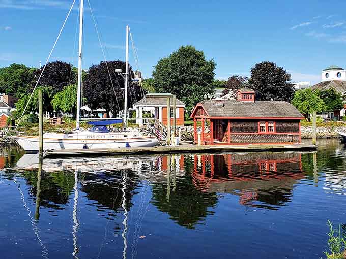 Sailboats bob beside historic buildings, creating reflections that look like a Bob Ross painting came to life minus the happy trees.