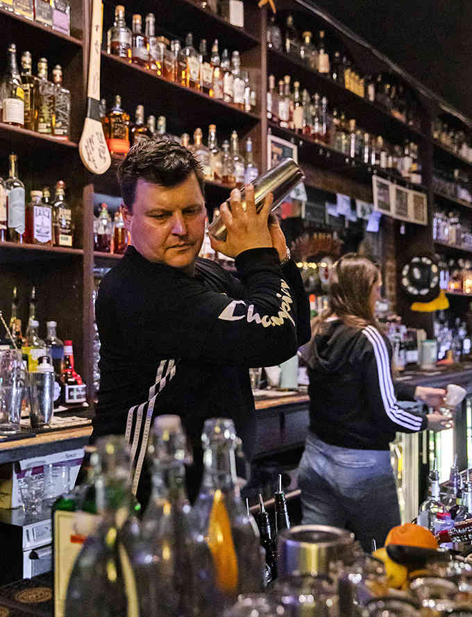 Behind every great pub stands skilled bartenders who know their craft, shaking cocktails with practiced precision and flair.