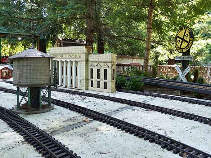 Miniature buildings including "Union Station" line the tracks, creating a detailed railway town that delights visitors of all ages.