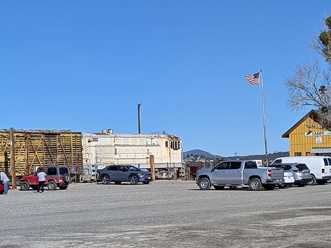 The parking area where modern cars meet vintage trains, a perfect collision of past and present under California skies.