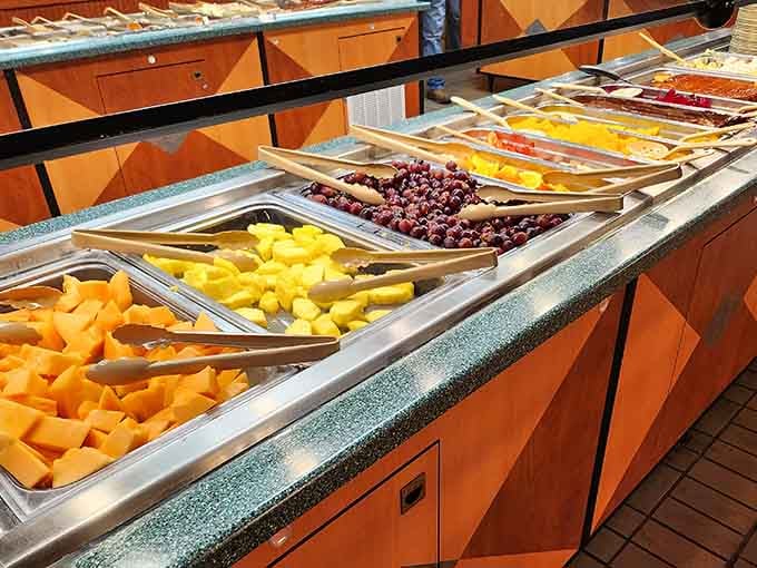 Fresh fruit glistening under buffet lights, providing the nutritional alibi for your third dessert plate later.