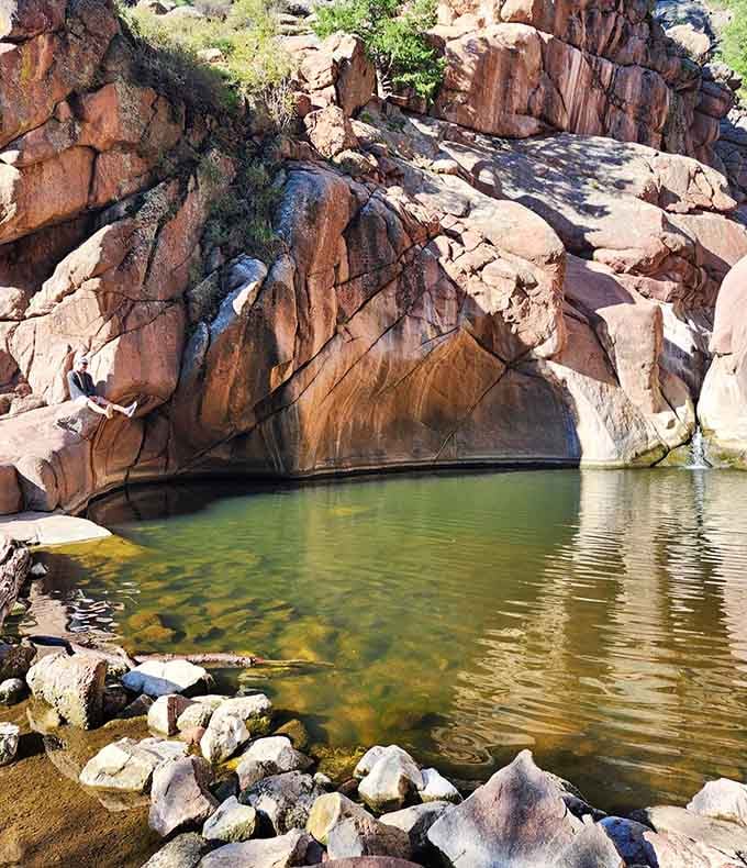Crystal-clear water pooled between ancient rocks creates a swimming hole that puts every public pool to shame.