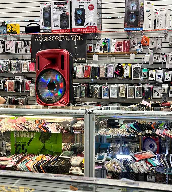 Phone cases and Bluetooth speakers stacked behind glass, proving technology and bargains can absolutely coexist peacefully together.