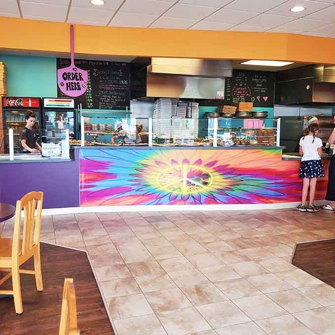 That vibrant tie-dye counter design tells you everything about the fun, creative spirit happening behind those pizza ovens.