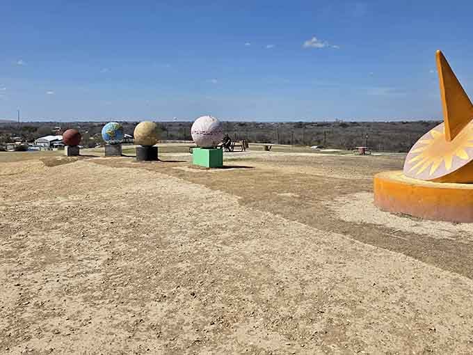 Planetary sculptures dot the landscape like a miniature solar system, adding educational whimsy to outdoor exploration.