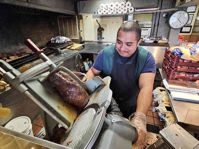 Fresh beef being sliced with the kind of precision that comes from years of practice and pride.