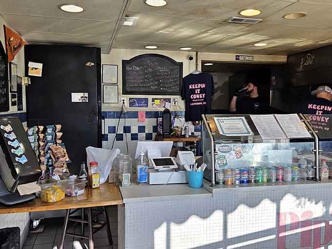 The no-frills counter and cheerful blue tile create an atmosphere where the food does all the talking.
