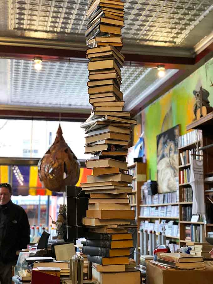 This gravity-defying book tower is either impressive merchandising or someone showing off their engineering degree creatively.