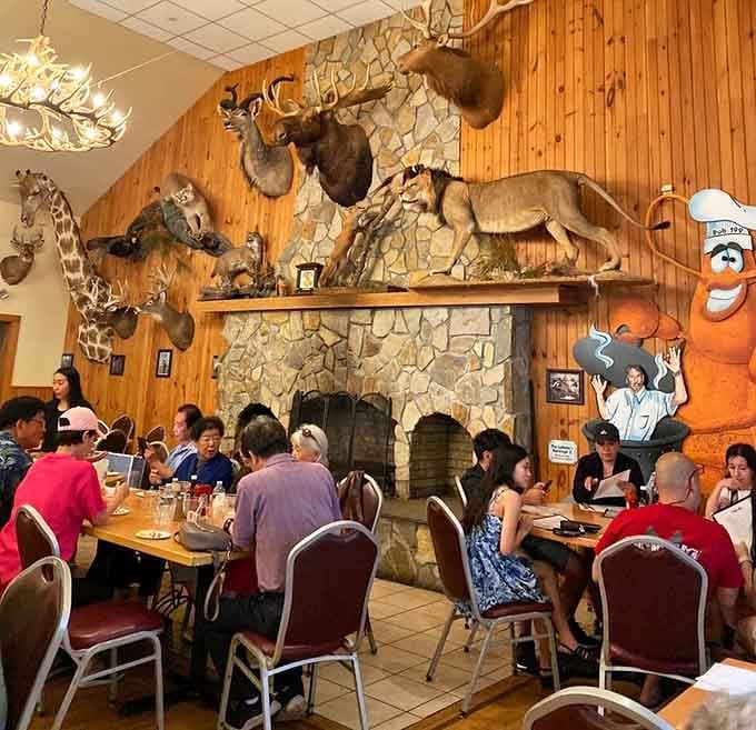 Diners enjoying their meals beneath a giraffe's watchful gaze, because this is just a normal Tuesday at Pub 199.
