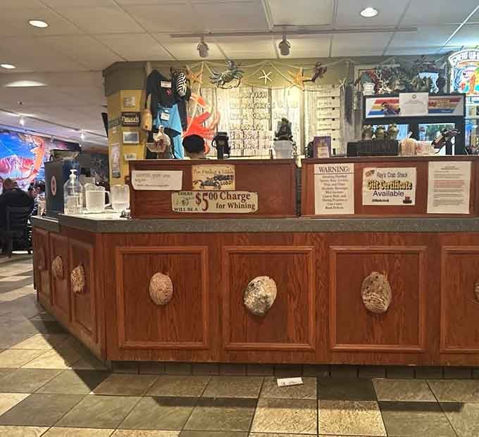 The payment counter adorned with ocean treasures and customer photos shows this is where community and cuisine come together.