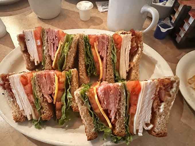 This towering club sandwich stacked with layers of turkey, bacon, and fresh vegetables could feed a small army, or one very happy person.