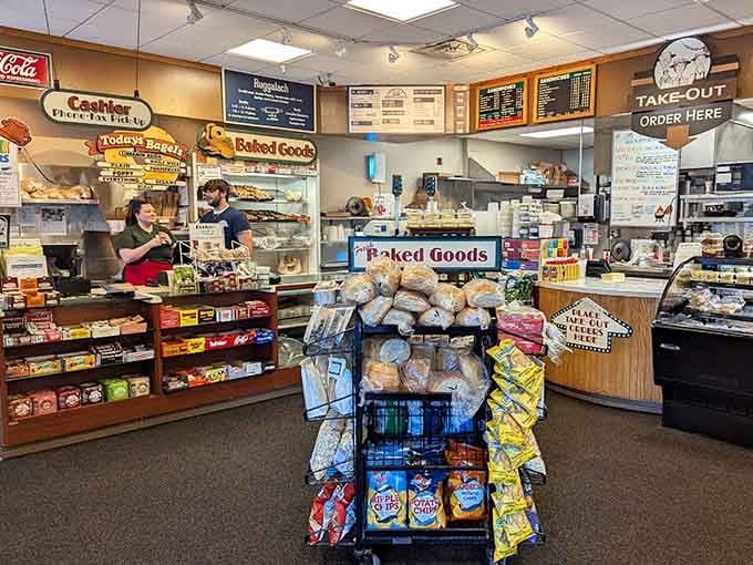 The cashier area where dreams of pastrami become reality, surrounded by baked goods tempting you to expand your original order significantly.