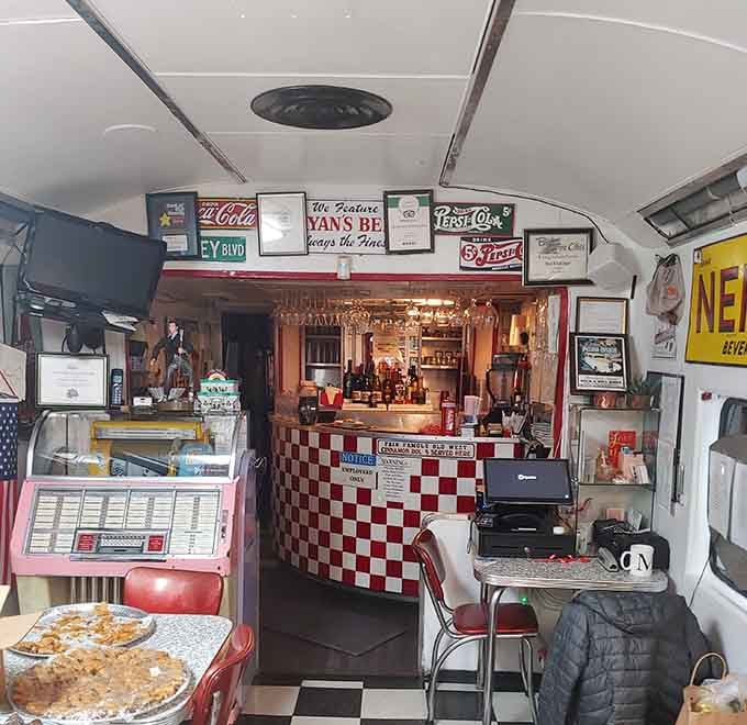Vintage signs, checkered counters, and nostalgic collectibles transform this working kitchen into a rock and roll museum.