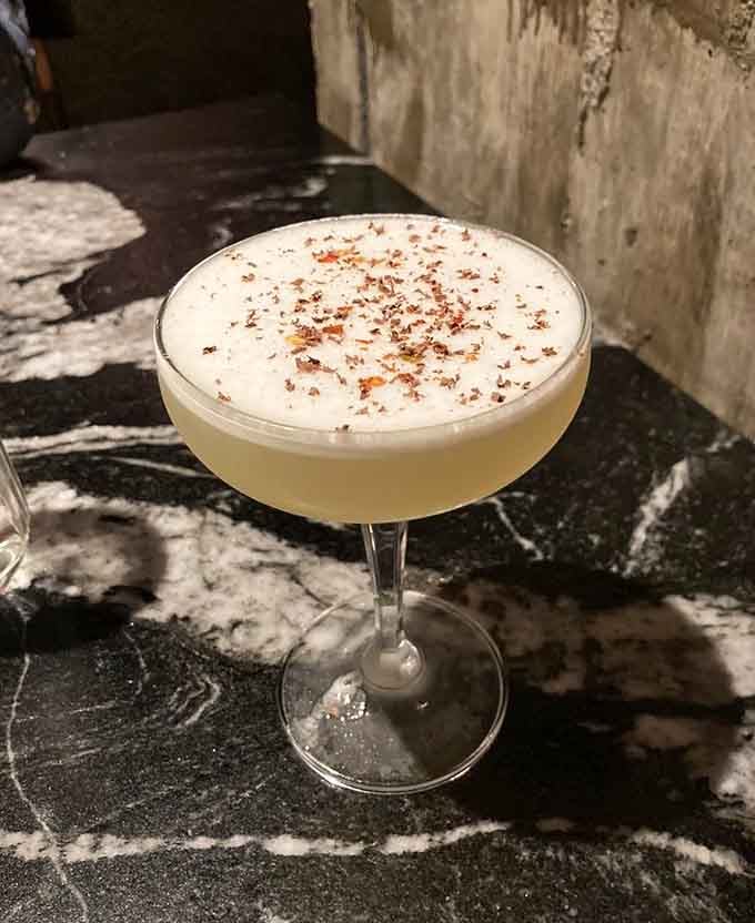 This frothy cocktail with spiced rim looks like someone turned autumn into something you can drink.
