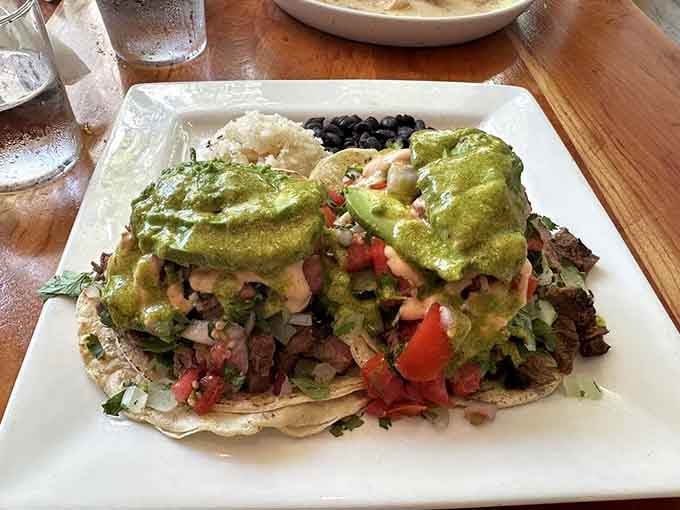 Tacos topped with enough fresh salsa verde to make you reconsider every sad taco you've ever eaten before this.