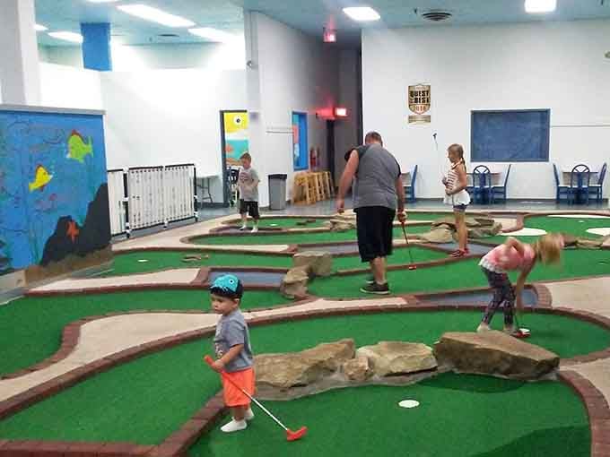 Indoor mini golf adds another activity to the mix, because apparently kids still have energy left somehow.