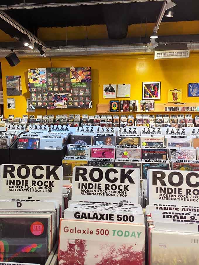 Bright yellow walls and perfectly organized sections make finding your favorite genre feel like a treasure hunt.