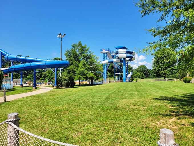 Manicured lawns frame the blue slides beautifully, proving that waterparks can actually be landscaping masterpieces too.