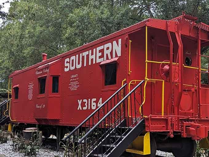 The Southern Railway caboose sits ready for photos, retired but still looking sharp in red.