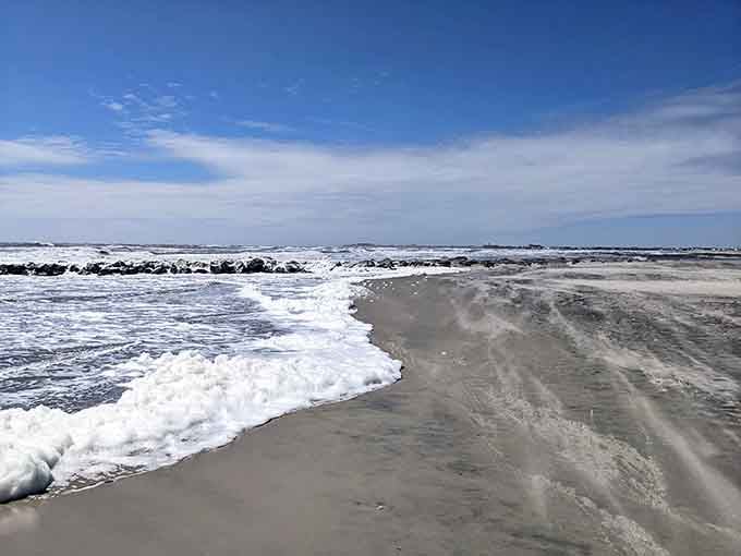 Sea foam swirling around ancient rocks creates patterns that no artist could ever quite replicate perfectly.