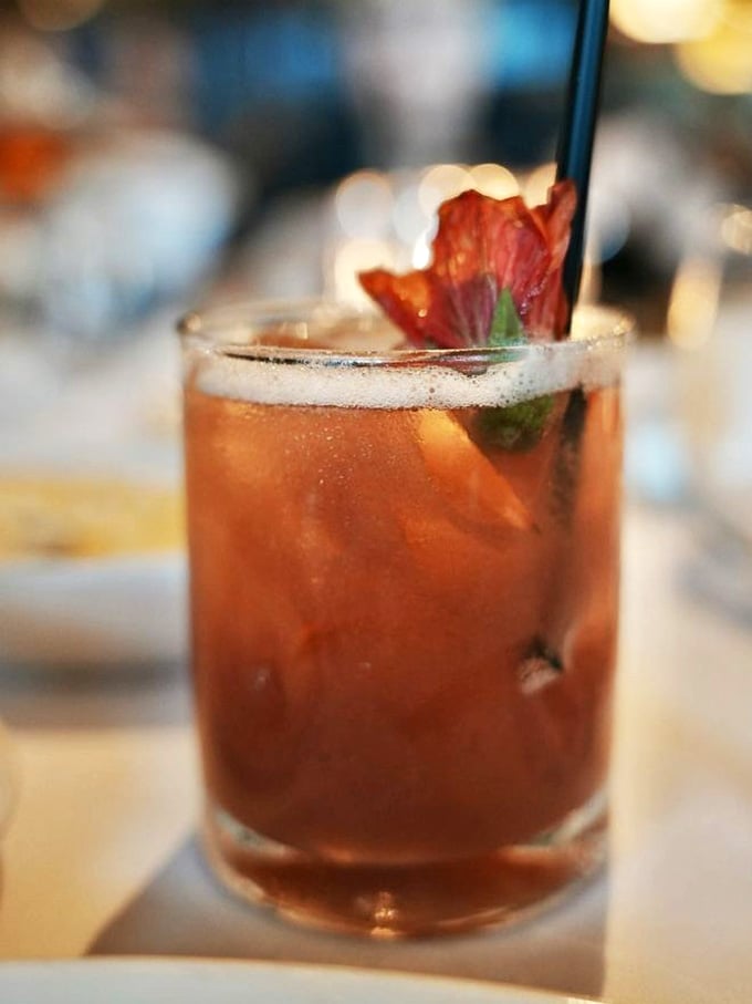 Cocktails garnished with edible flowers, because your drink should look as good as you feel ordering it.